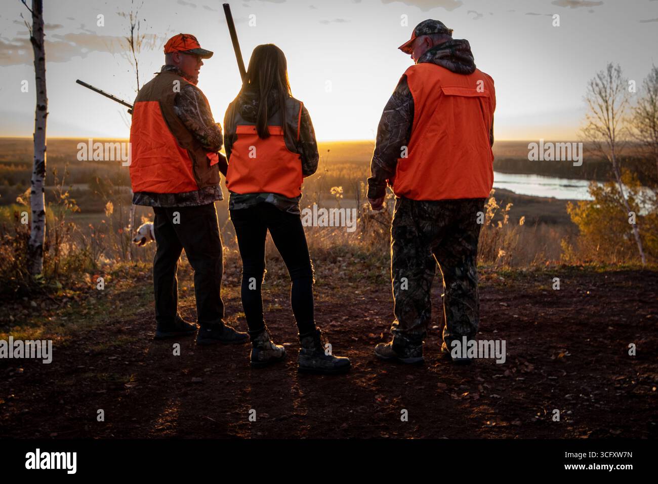 Rear view of three people going hunting, Minnesota, USA Stock Photo - Alamy