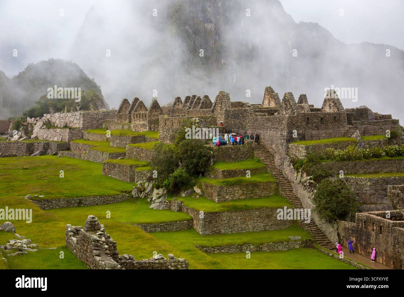 Visitors explore the “urban” or residential areas of the ancient site ...