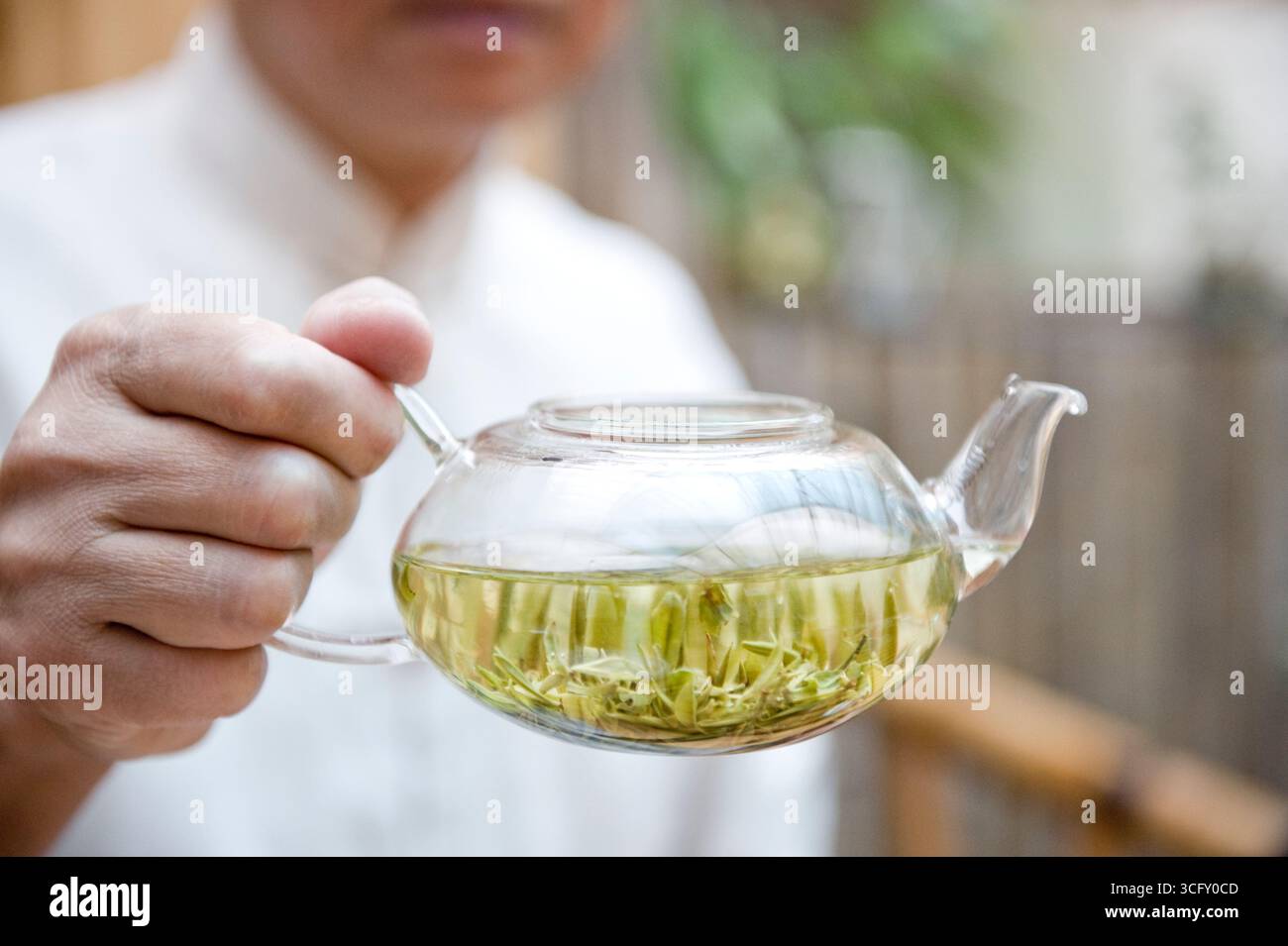 Minglou Chen, owner of the Minglou Tea House displays one of his ...