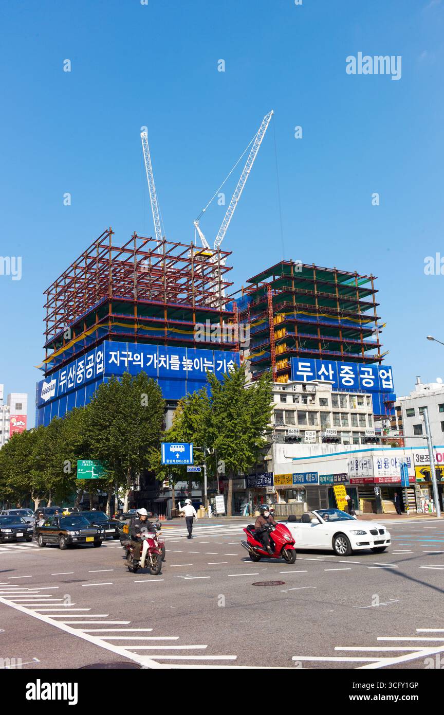 Twin buildings under construction on a busy intersection Stock Photo ...