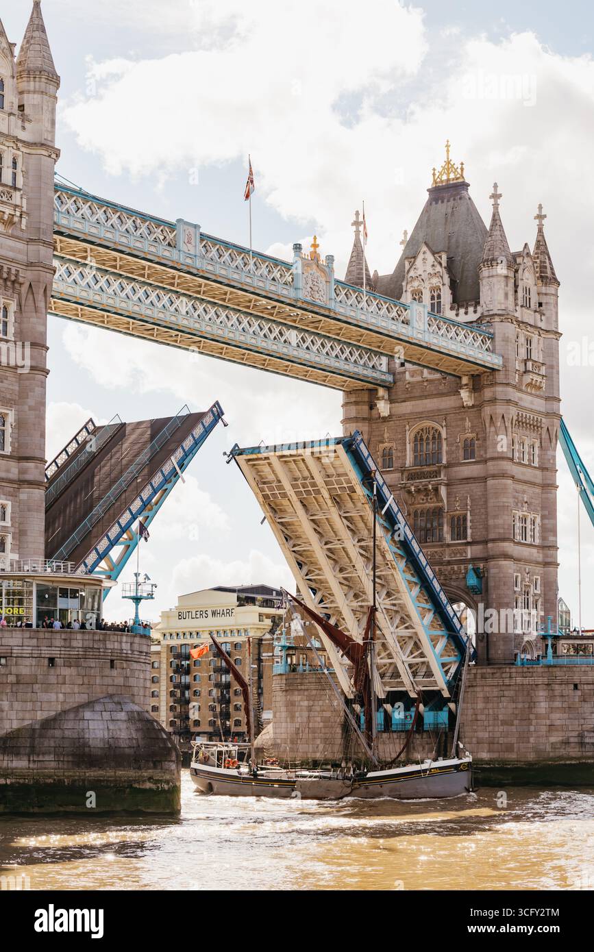 The raised bascules of Tower Bridge which crosses the River Thames ...