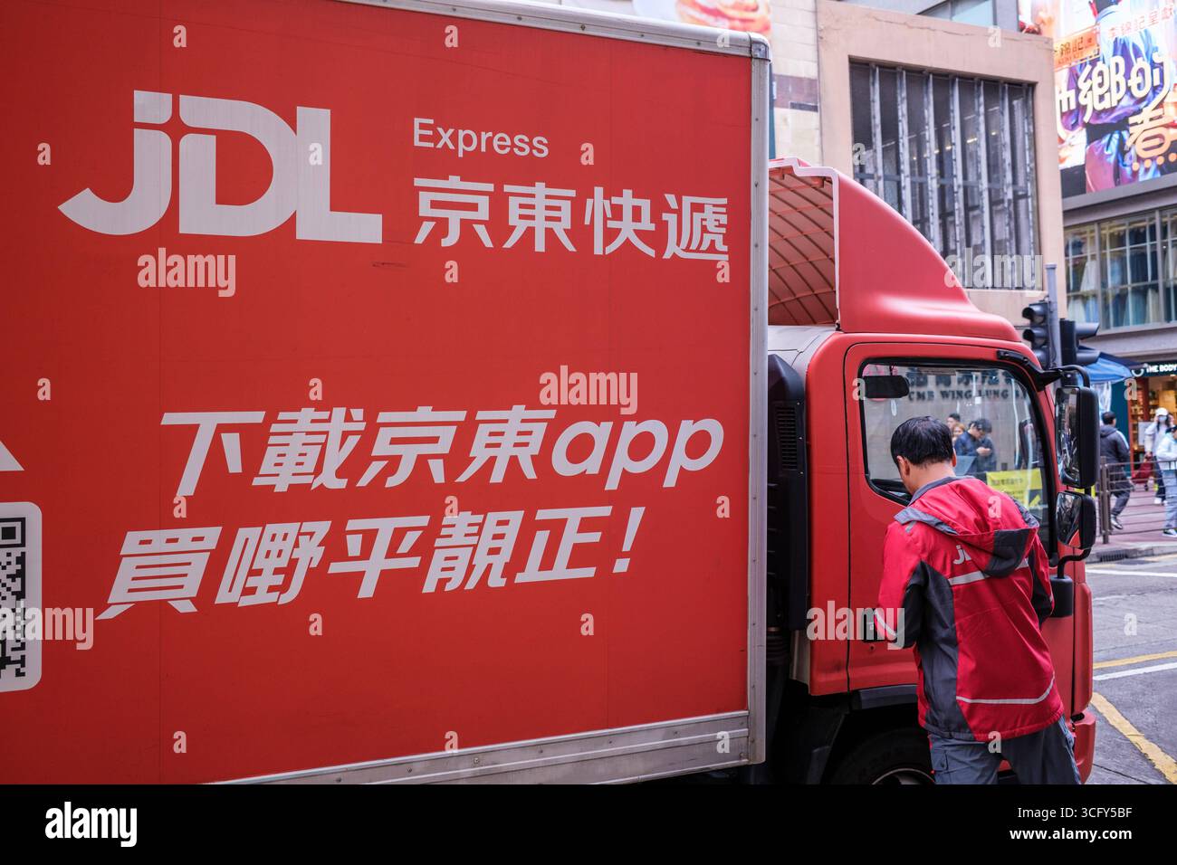 Hong Kong Daily Life A worker next to a JDL Express delivery truck on ...
