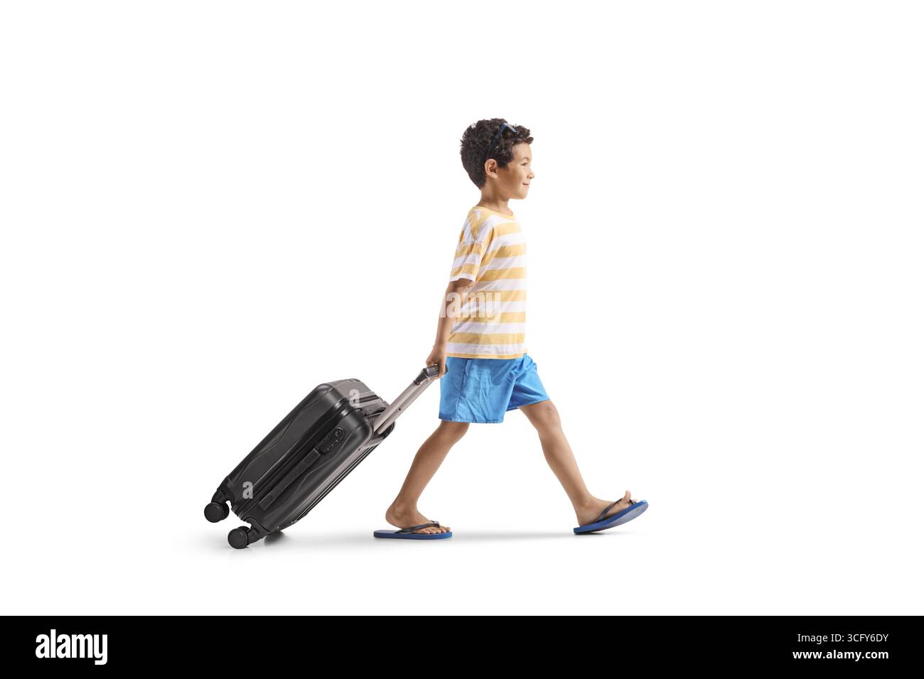 Boy walking and pulling a suitcase isolated on white background Stock ...