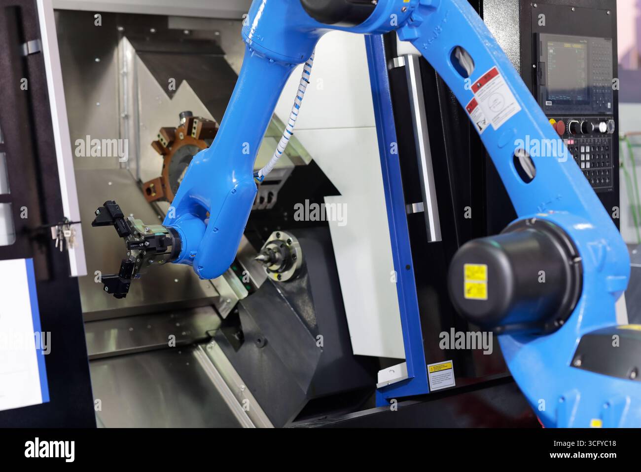 CNC lathe machine with collaborative robot. Work cell for automation of placing parts into CNC ...