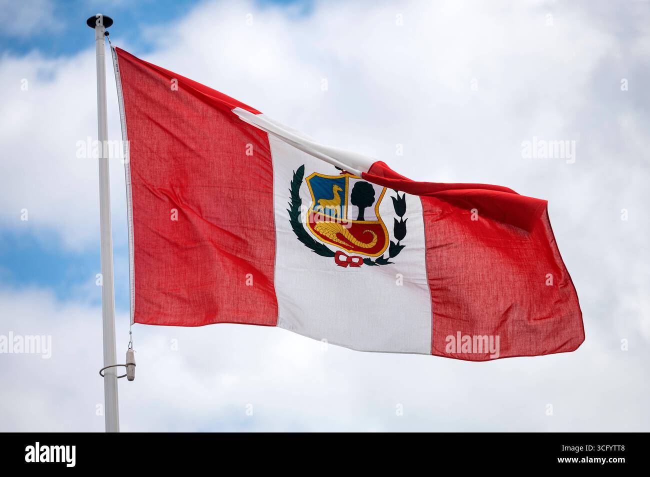 Peru flag fluttering in the wind with a blue sky and cloud background ...
