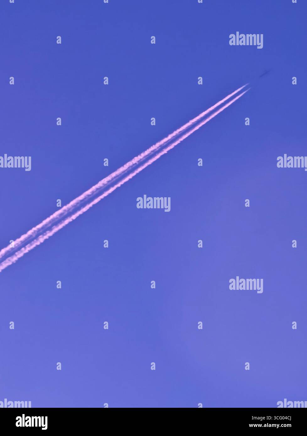 Jet airplane with purple contrails in clear sky, minimalism, vertical ...