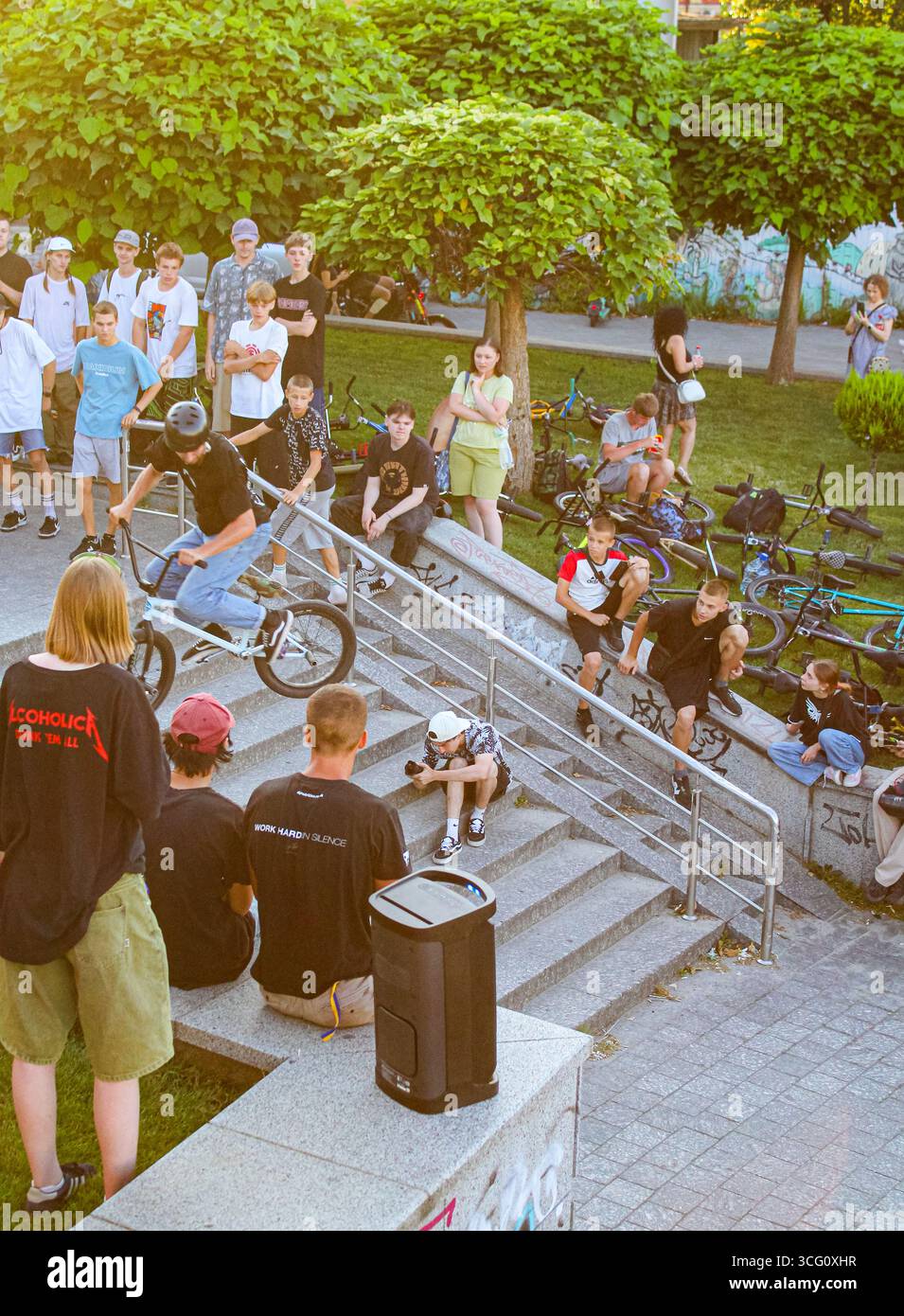 A skilled boy performs an impressive bicycle trick for a crowd in Kyiv ...