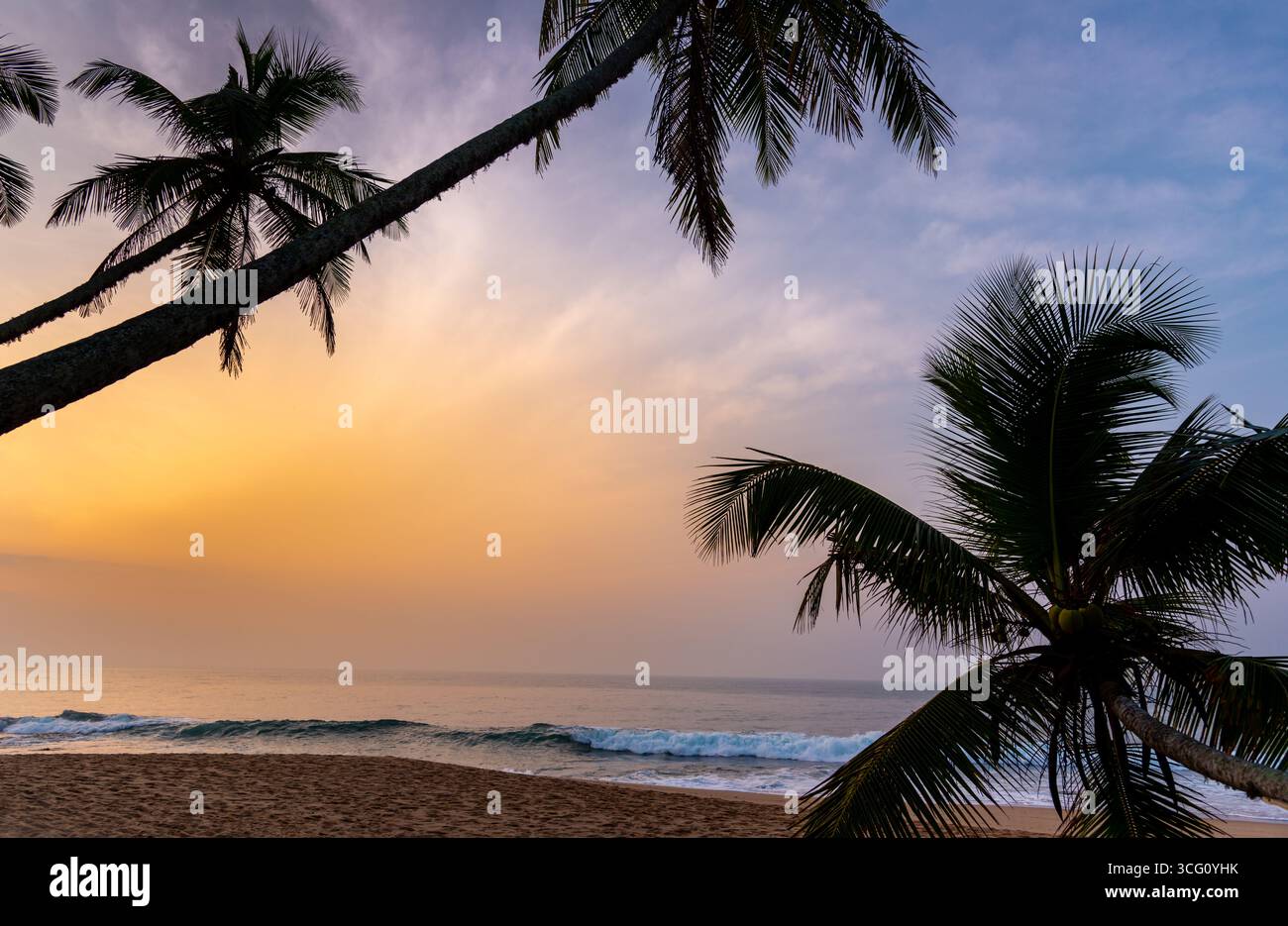 Beautiful sunrise over tropic beach Stock Photo - Alamy