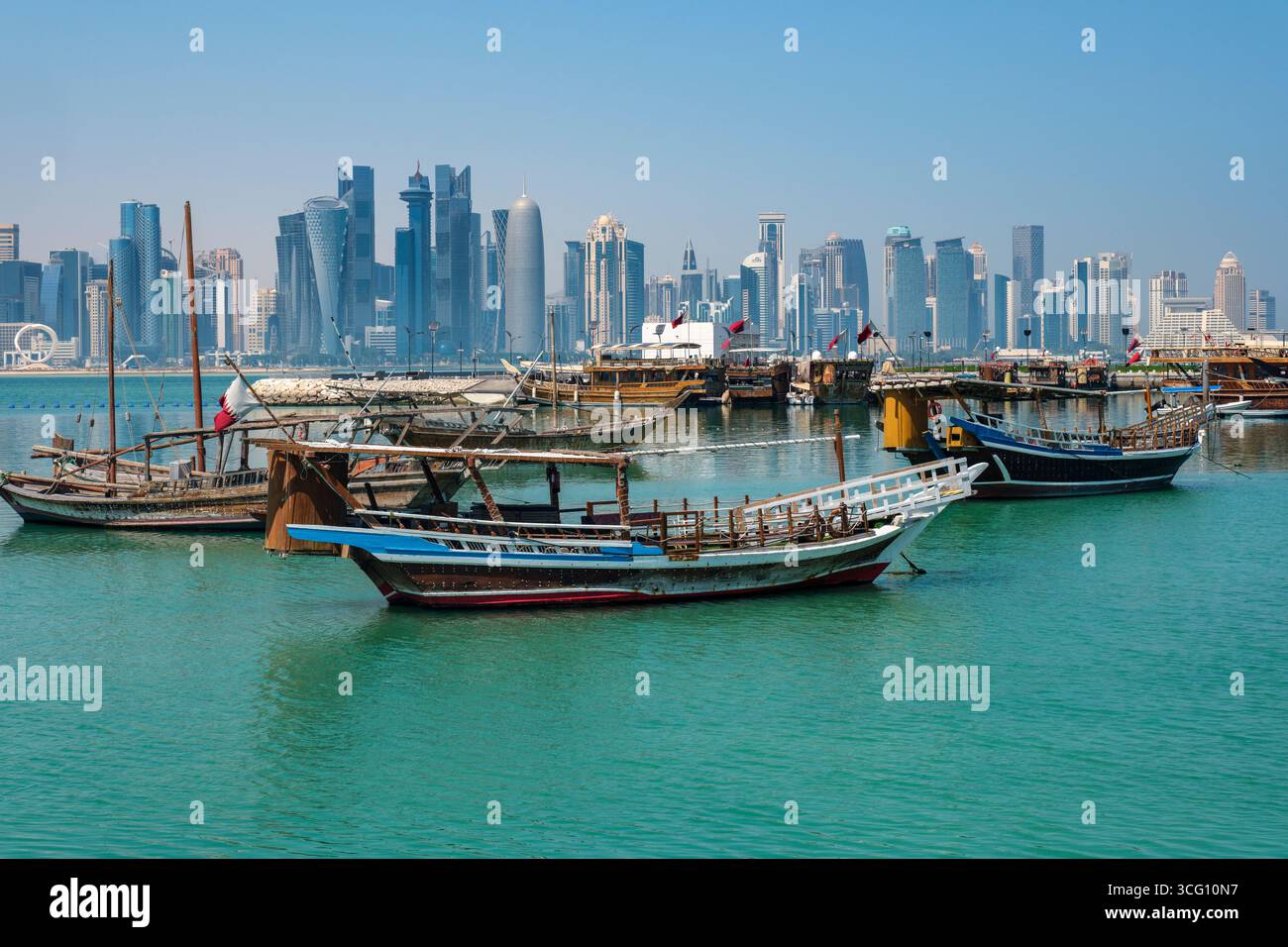 Traditional dhows moored in Doha Bay with a backdrop of the ultra ...