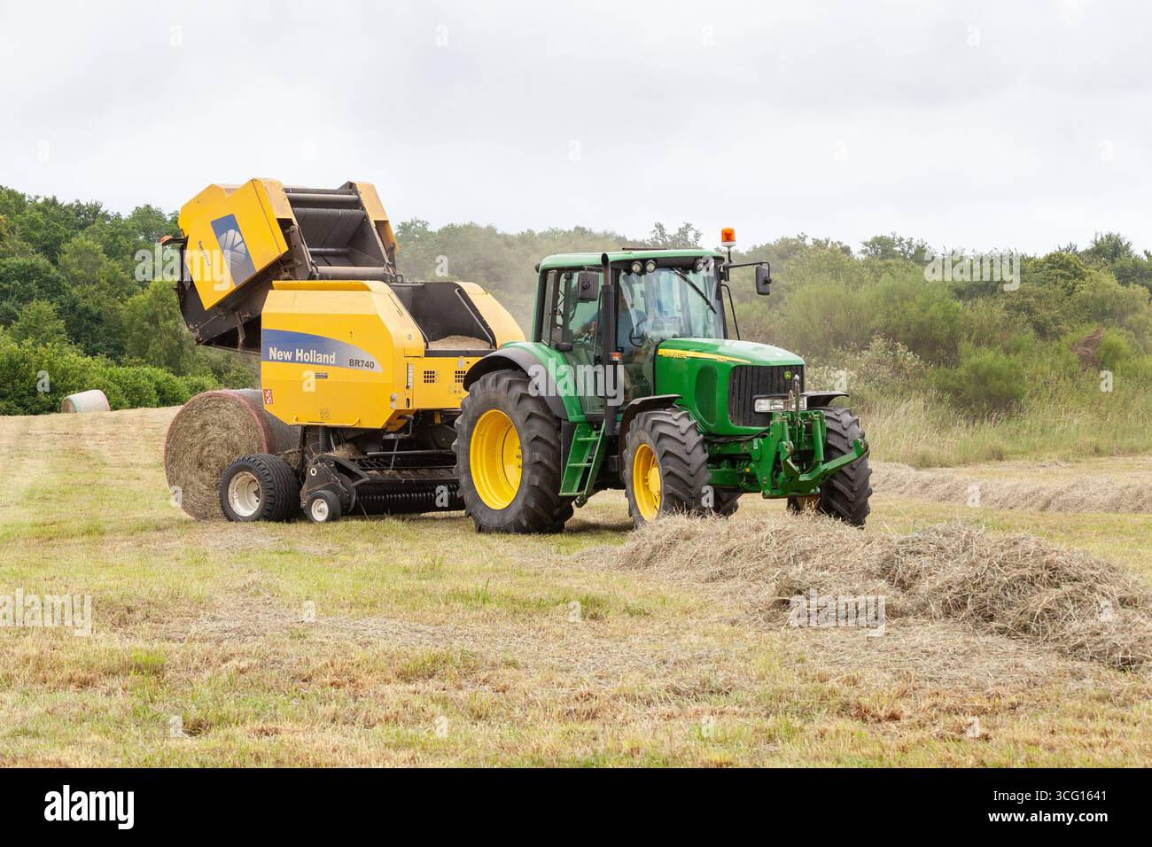 Circular hay bale exiting baler hi-res stock photography and images - Alamy