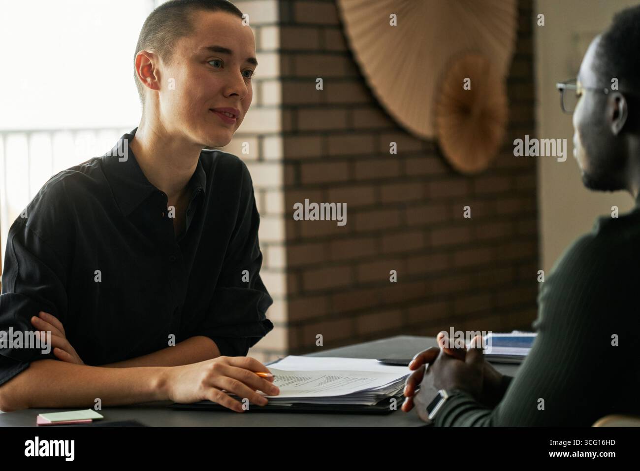 Young Caucasian HR manager with short hair working in modern office ...