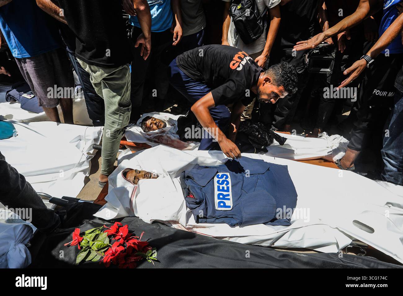 Palestinian mourners attend the funeral of Reuters photojournalist Hossam al-Masry, Al Jazeera ...