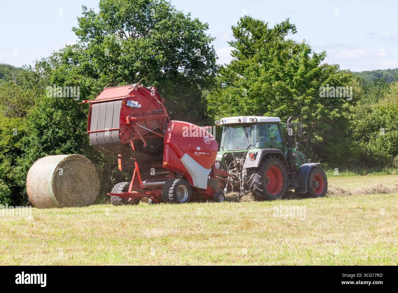 Circular hay bale exiting baler hi-res stock photography and images - Alamy