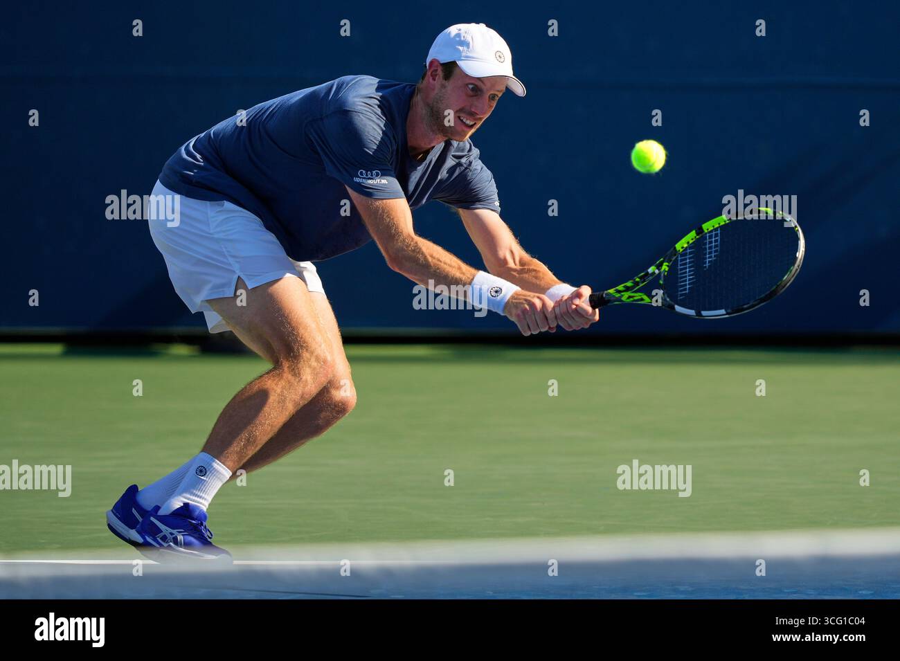 Botic van De Zandschulp, of the Netherlands, returns a shot to Holger ...