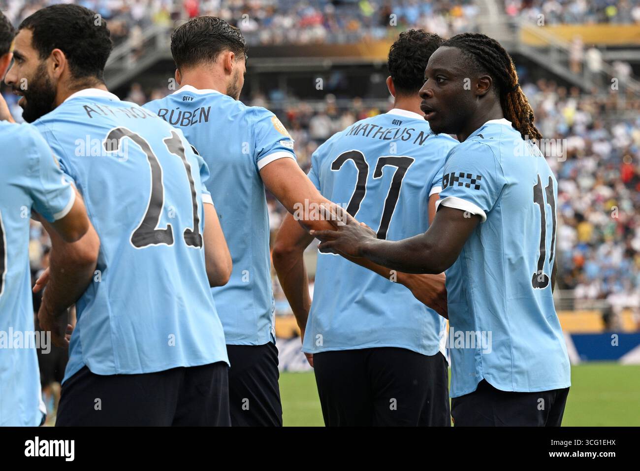 Manchester City's Jeremy Doku (11) celebrates with teammates after a ...