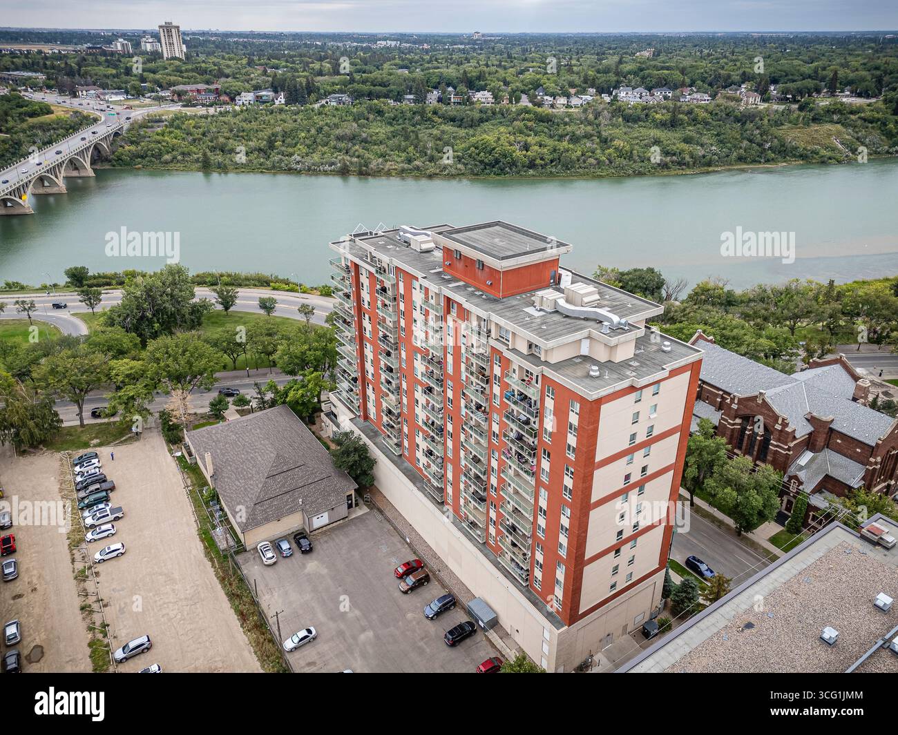 A large red building with a white roof sits on a city street. The ...