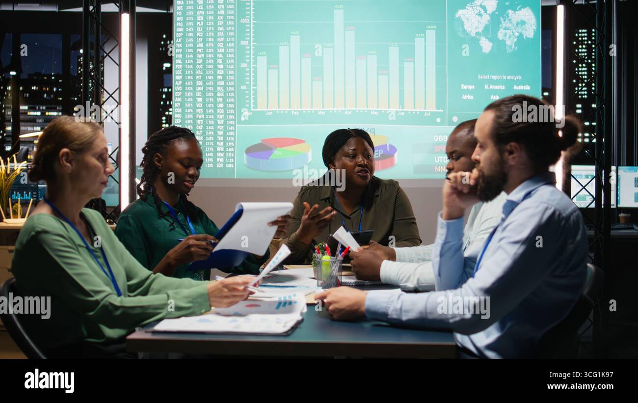 Multiethnic group of advisors reviewing data insights and financial ...
