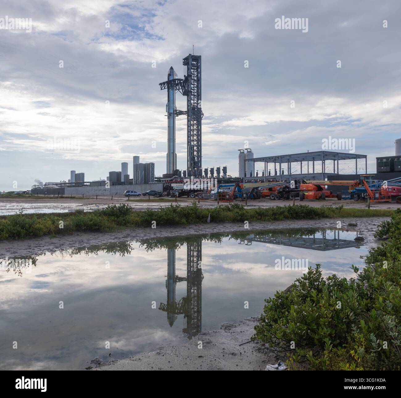 SpaceX Starship S37 B16 flight 10 reflecting in a water puddle next to ...