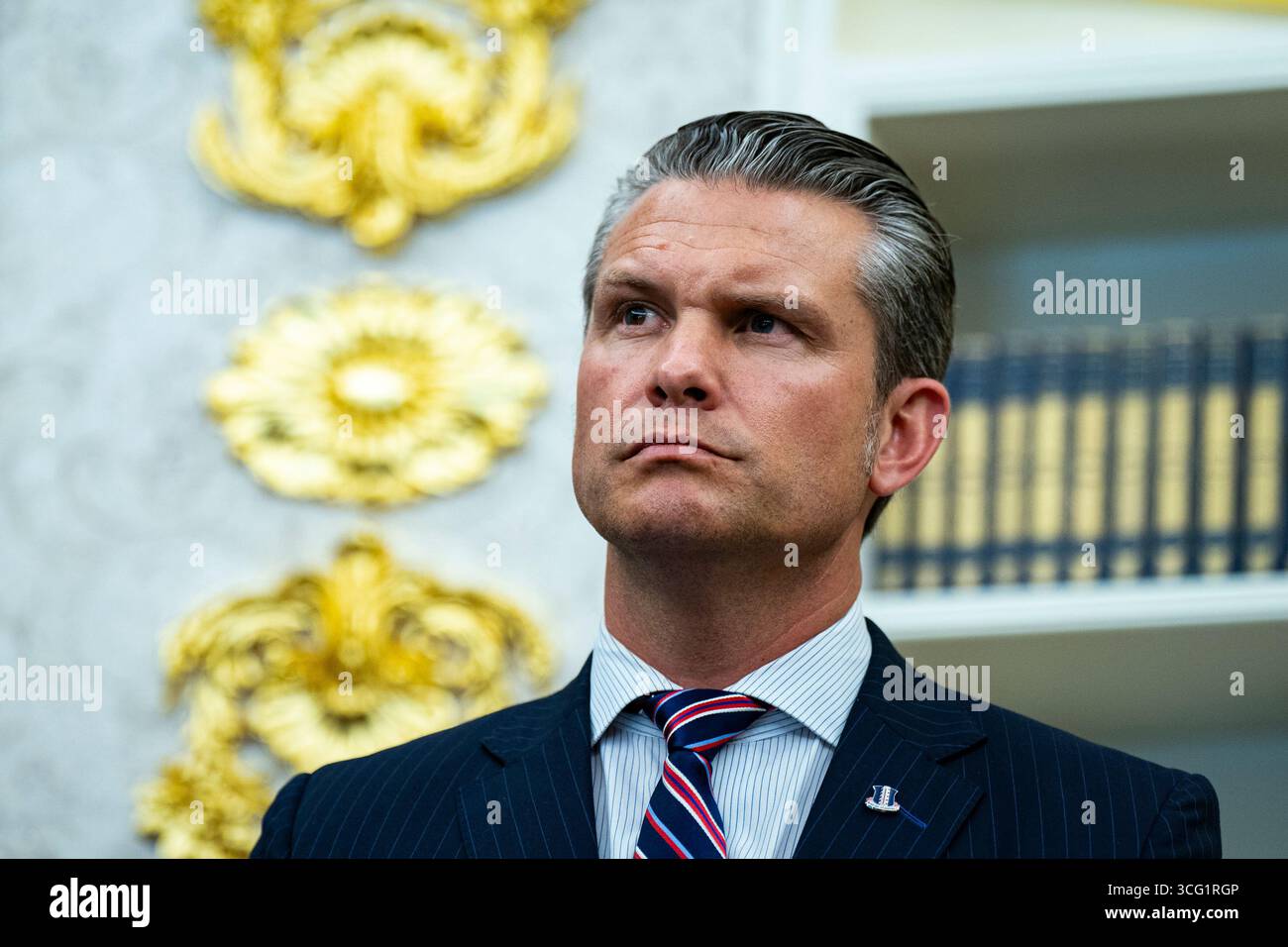Defense Secretary Pete Hegseth looks on as President Donald Trump signs ...