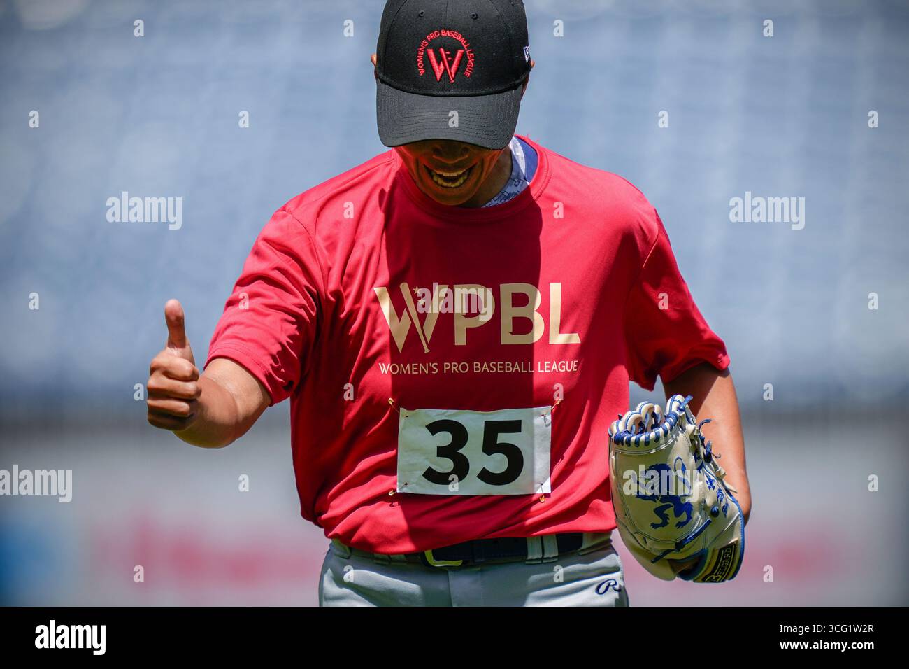 Ayami Sato reacts after pitching during a game on the fourth day of tryouts for the Women's ...