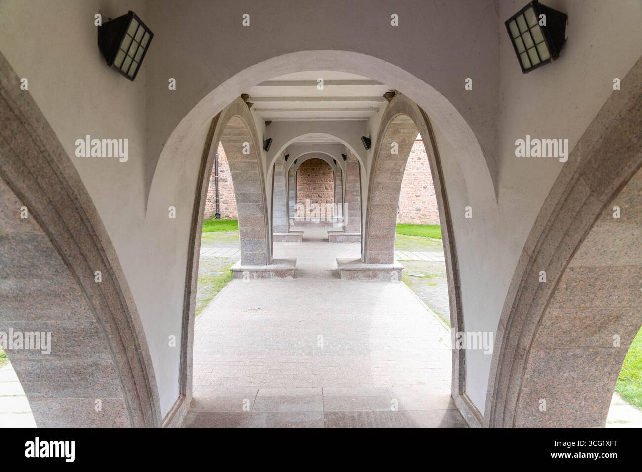 A marble Gothic passageway with an arched archivolt with colonnades ...
