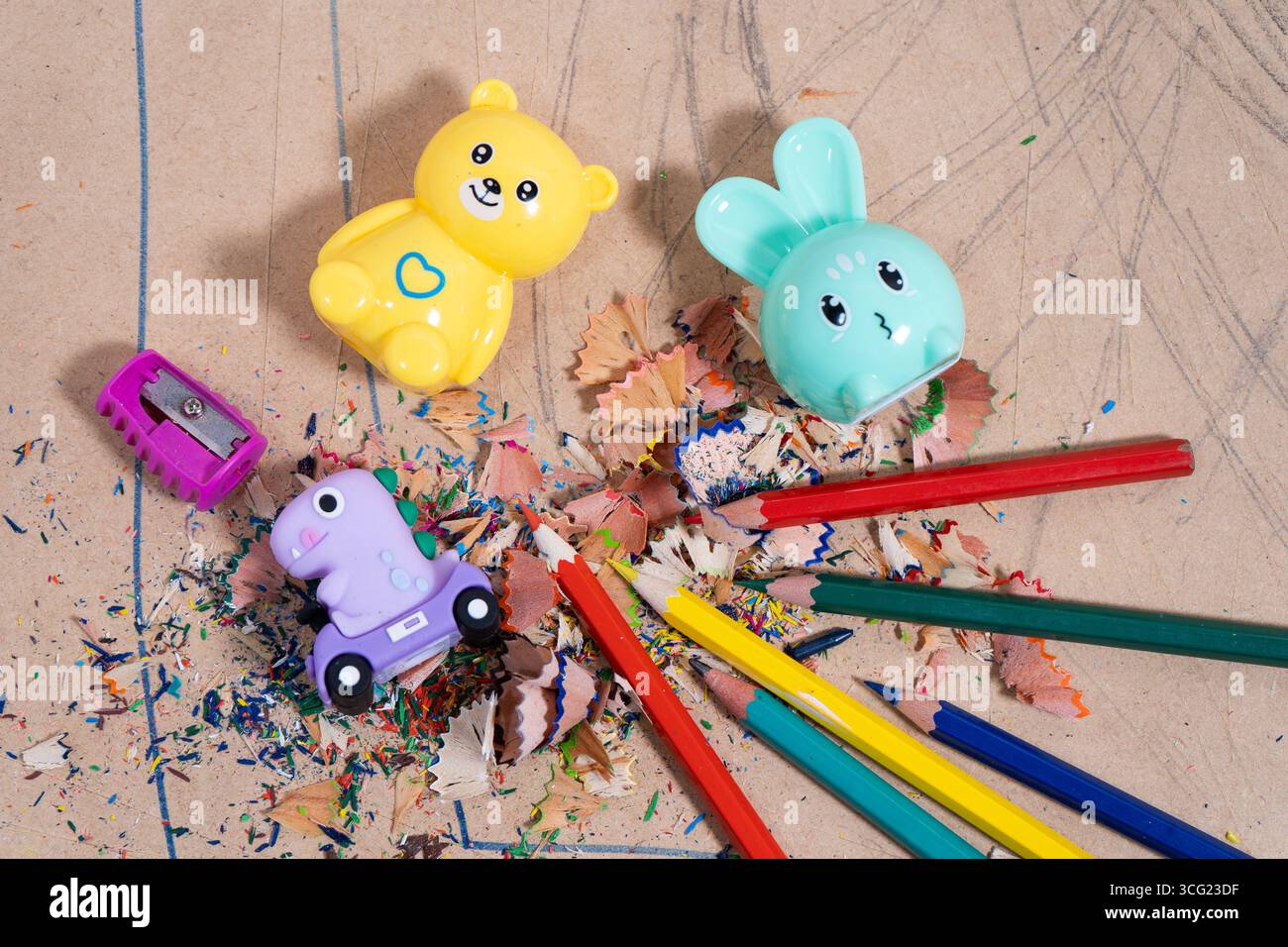 Colorful pencil shavings surround fun pencil sharpeners shaped like a ...