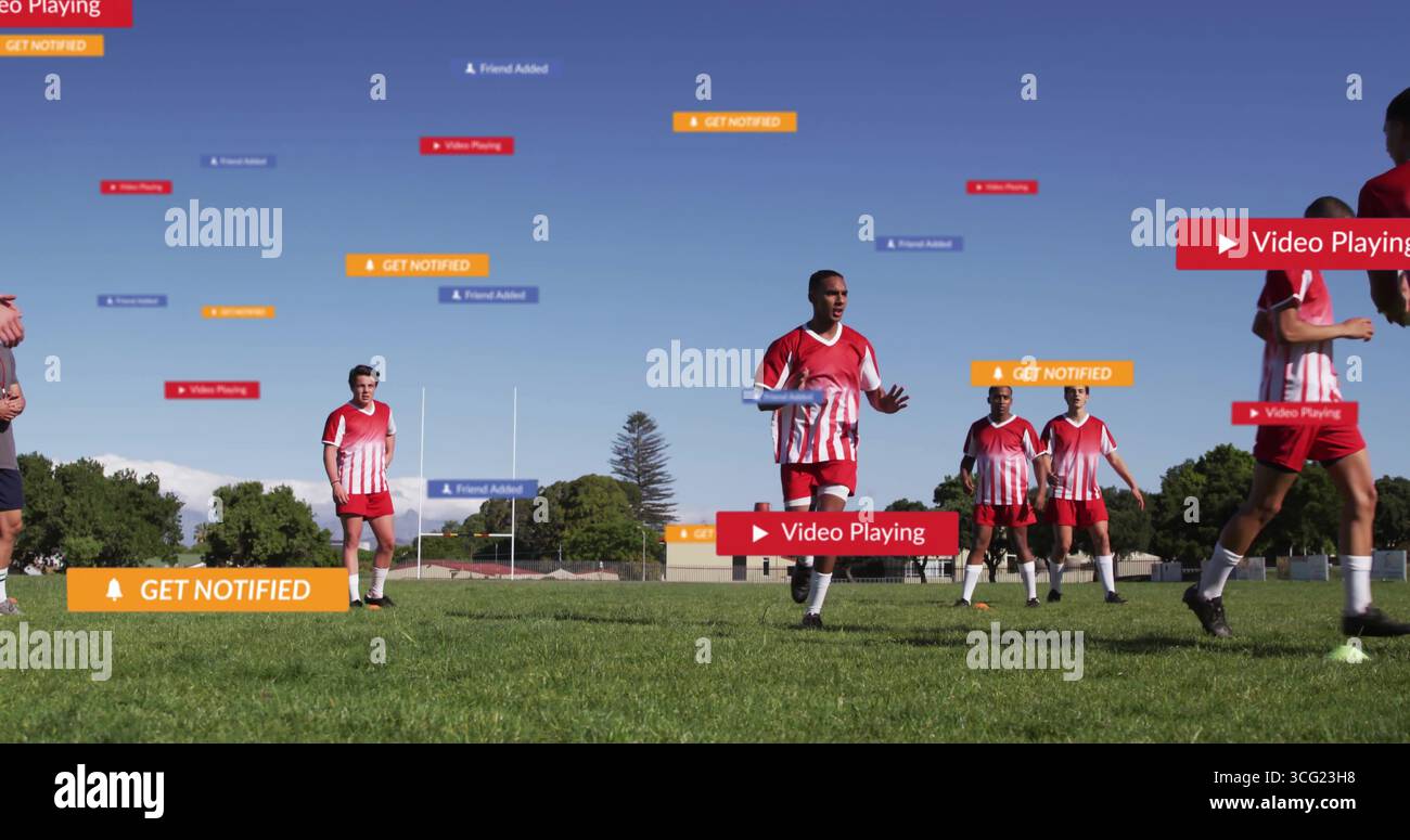 Running athlete in red jersey raising arms on outdoor soccer field ...
