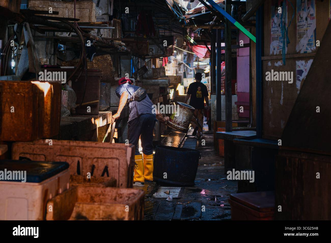 Balikpapan, Indonesia – July 22 2025: Market workers clean up the wet ...