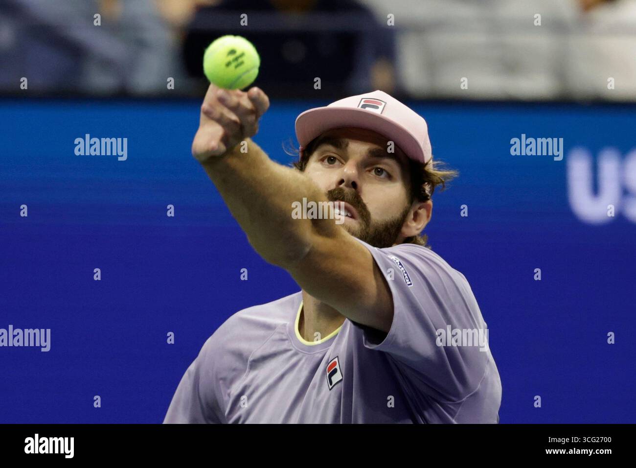 Reilly Opelka, of the United States, serves to Carlos Alcaraz, of Spain ...