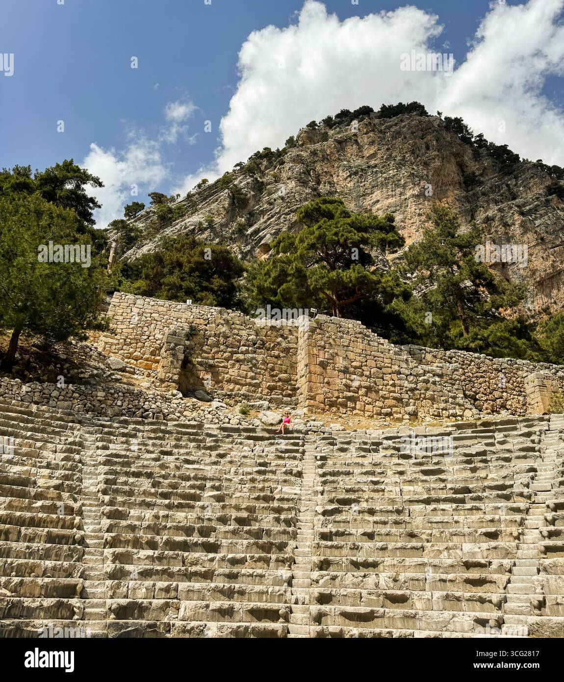 Explore ancient stone theater set against a majestic mountain backdrop ...