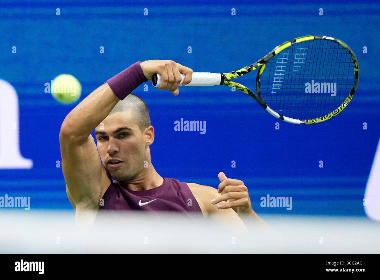 Carlos Alcaraz, of Spain, returns a shot to Reilly Opelka, of the ...