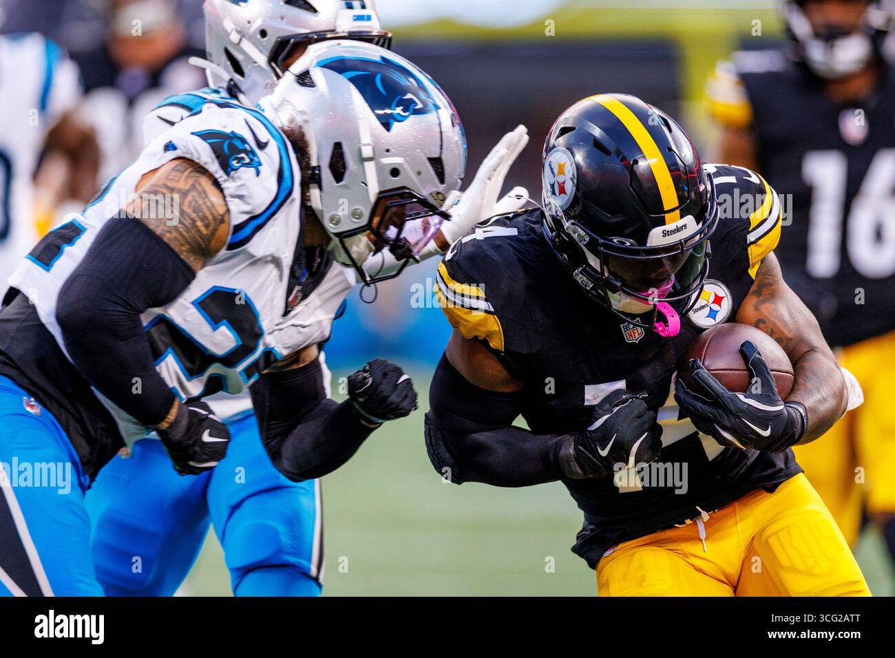 Pittsburgh Steelers running back Kenneth Gainwell (14) takes a hit from ...