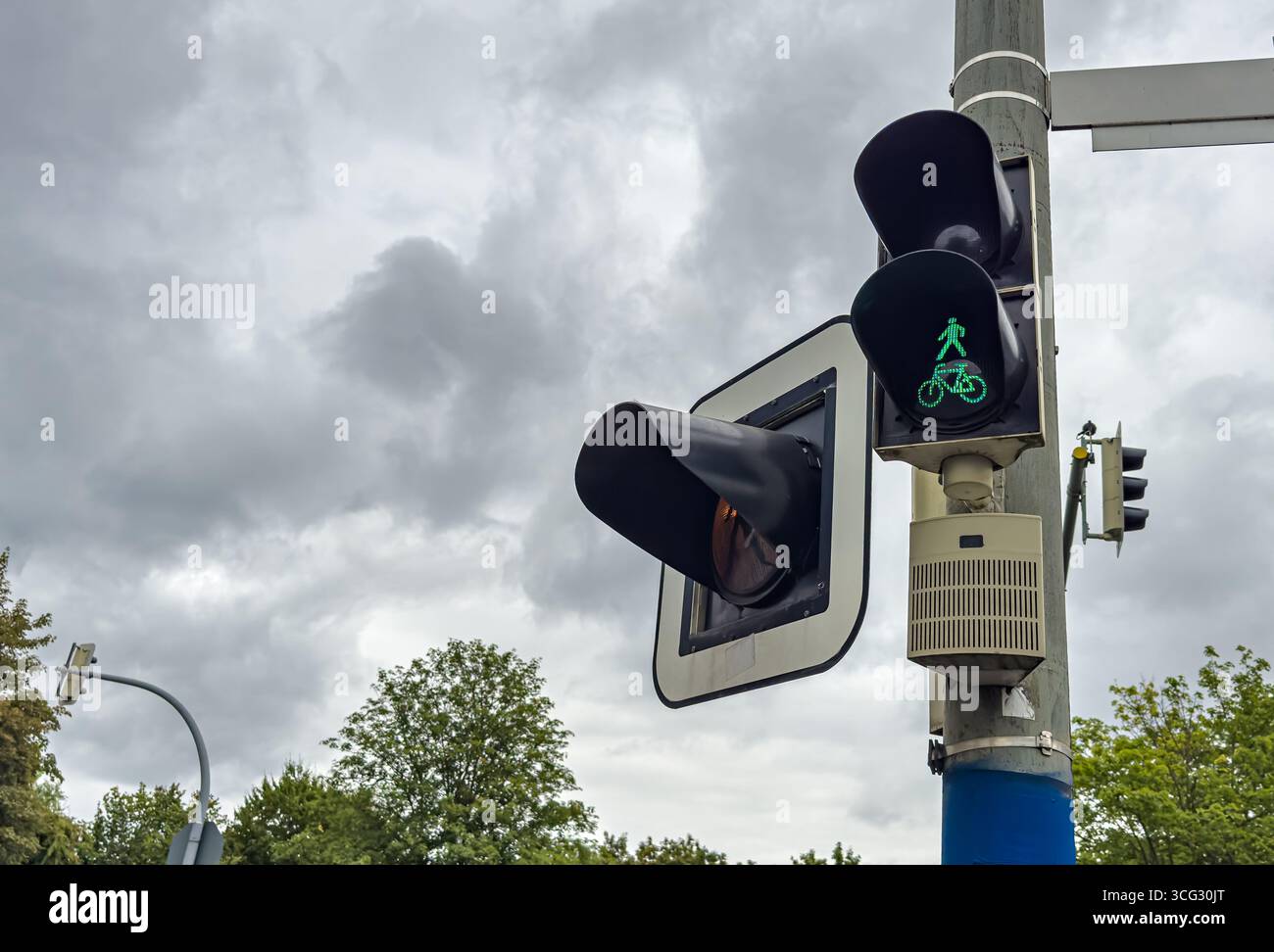 A pedestrian and bicycle signal is visible at an urban intersection ...