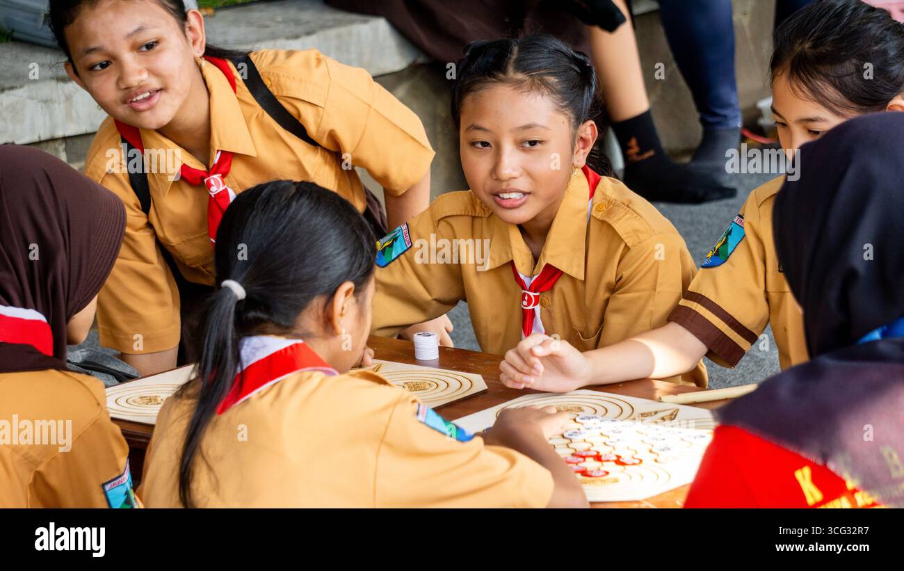 Children in elementary school scout uniforms play traditional ...