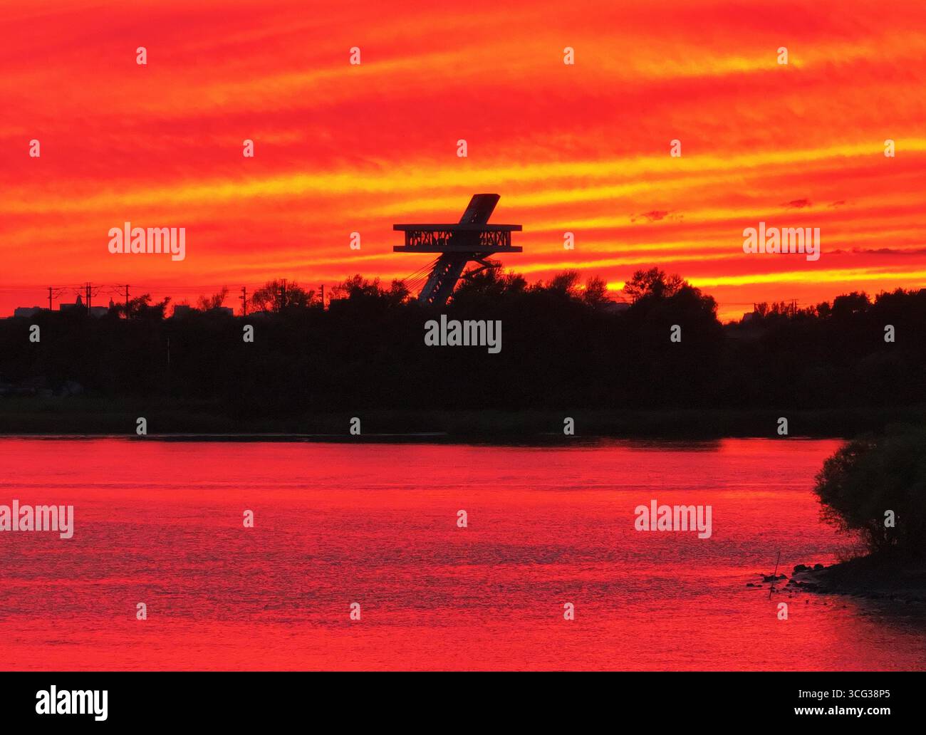 Sunset illuminates the sky over the Songhua River in Harbin City ...