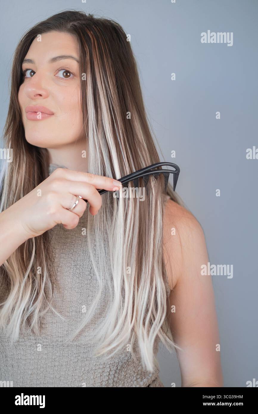 Young woman gently combing hair hi-res stock photography and images - Alamy