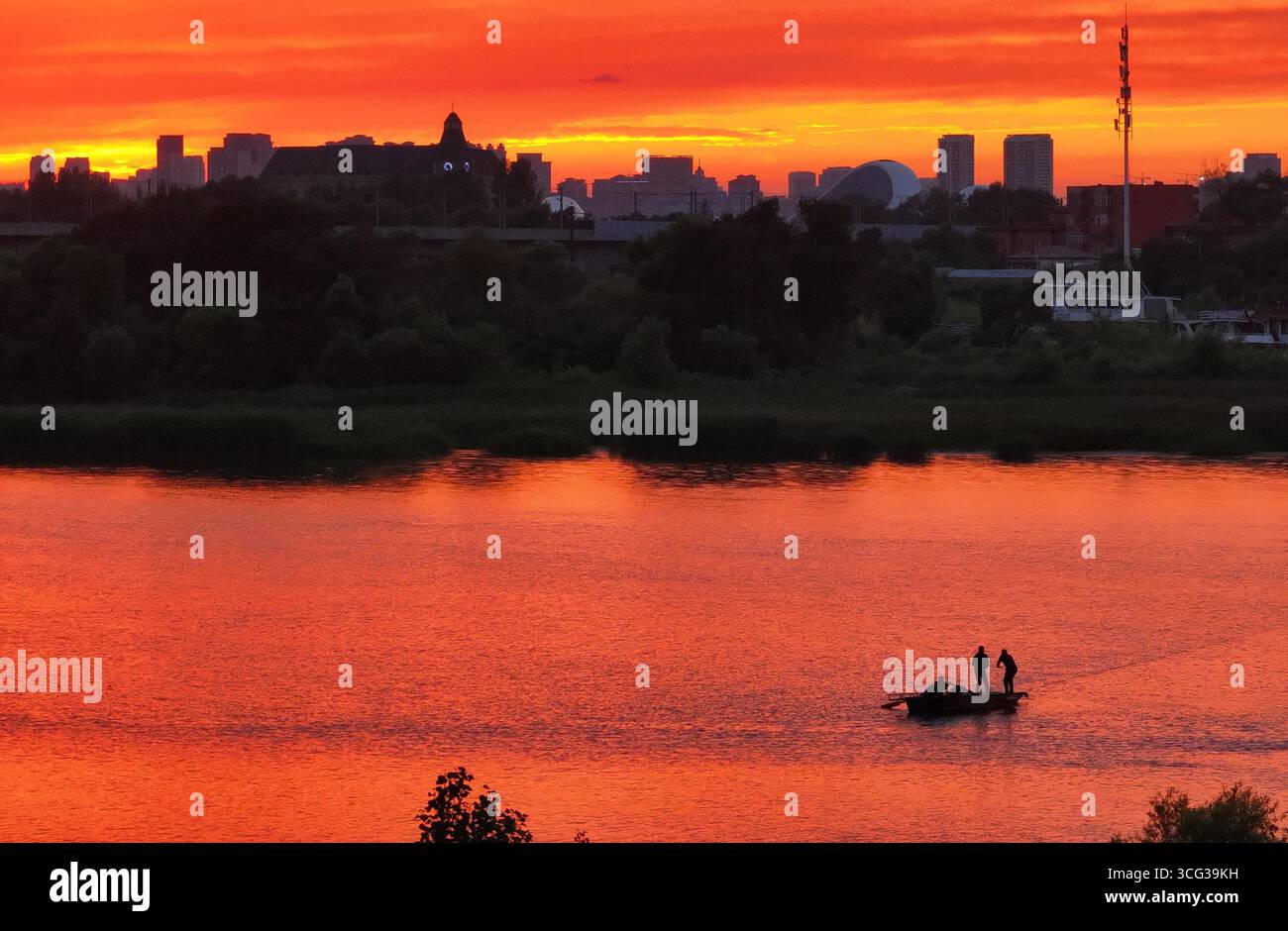 Sunset illuminates the sky over the Songhua River in Harbin City ...