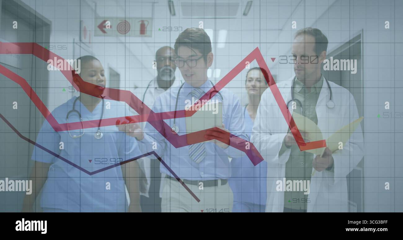 Walking medical team in scrubs and stethoscopes down hospital corridor ...