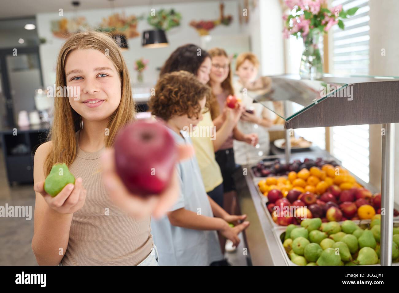A vibrant school cafeteria scene where students pick fresh fruits from ...