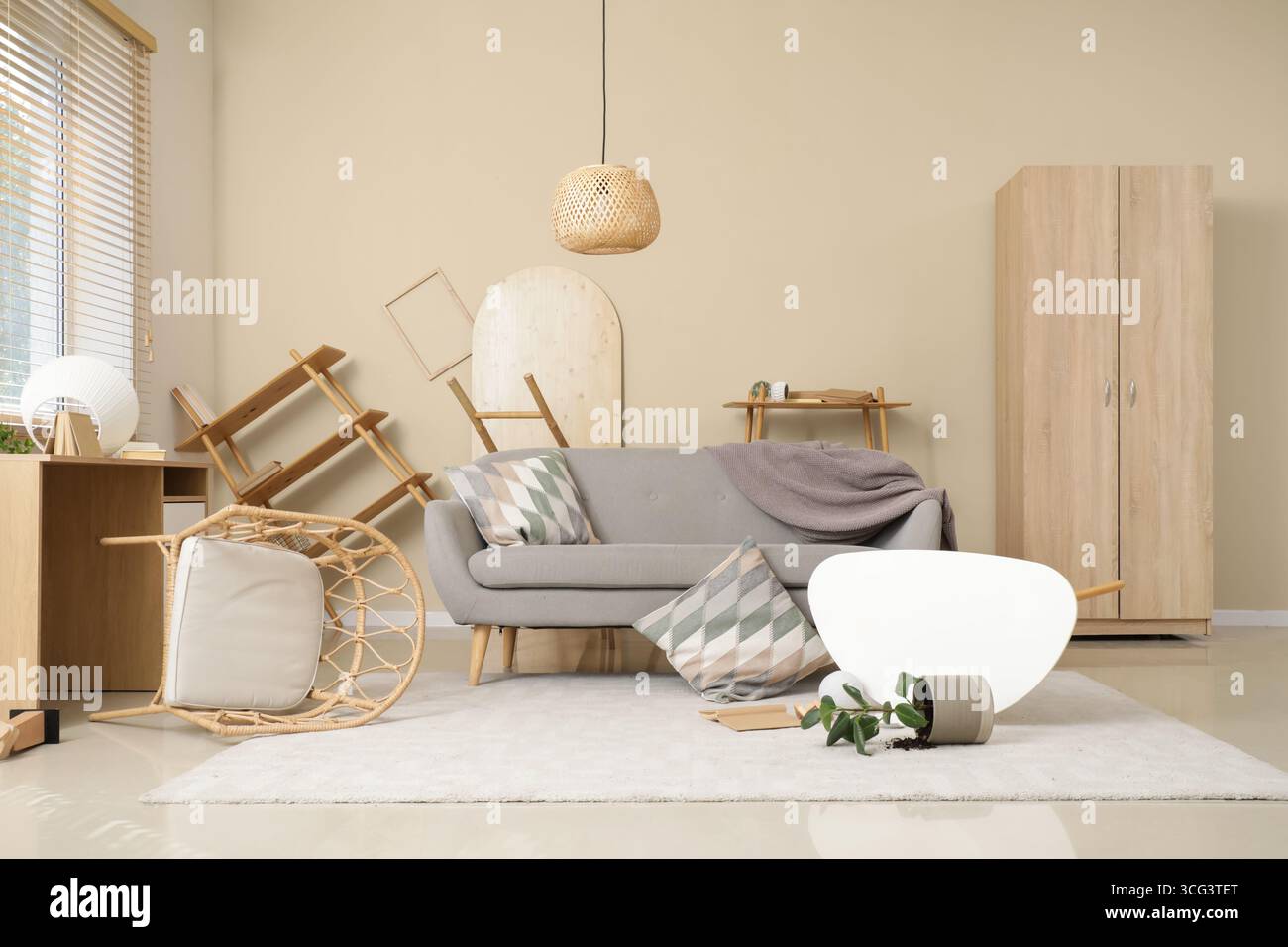 Interior of damaged living room with sofa and overturned furniture ...