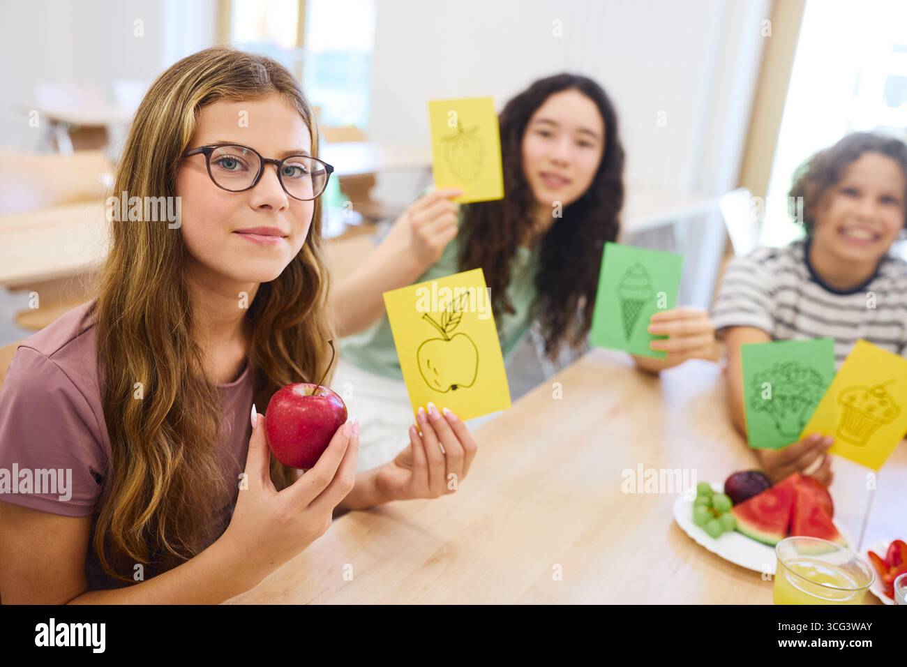 A group of school students participates in a cafeteria activity with ...