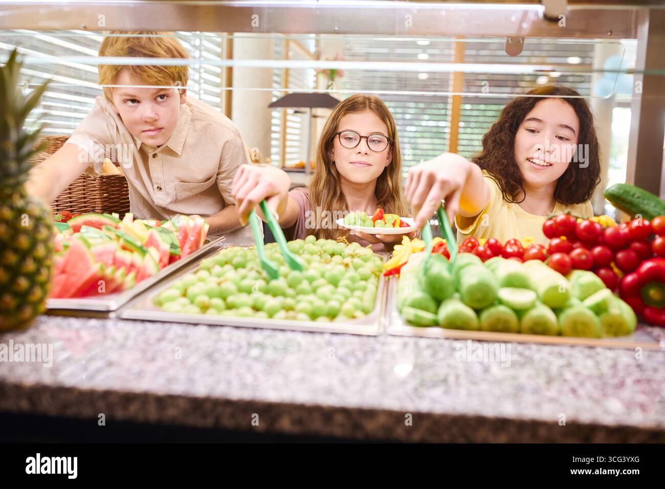 Schoolchildren choosing nutritious and colorful food items from a fresh ...
