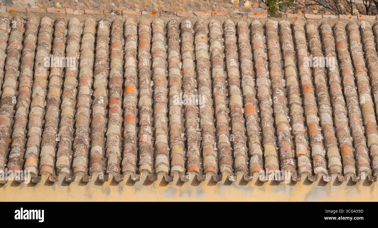 Closeup of traditional clay barrel roof tiles showing age, texture, and ...