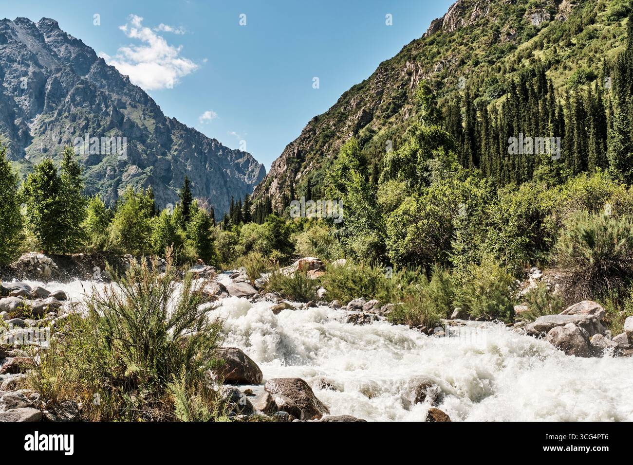 Mountain river with rapid whitewater, surrounded by rocky slopes and ...