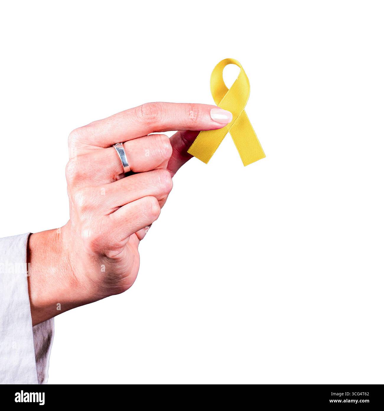 Woman’s hand holding a yellow ribbon over a white background. Symbol of ...