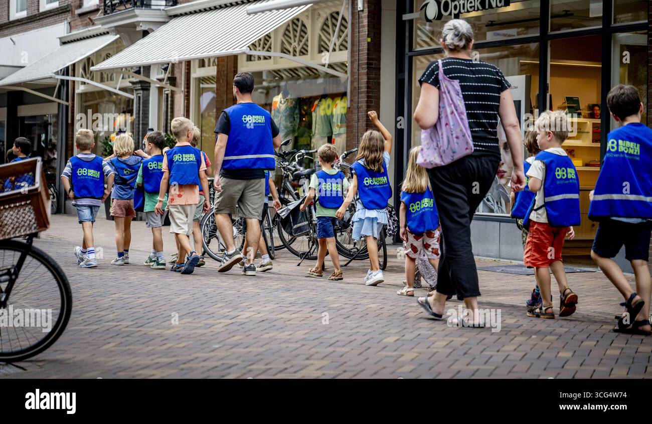 GOUDA Childcare walks with children in vests on the street ANP ...