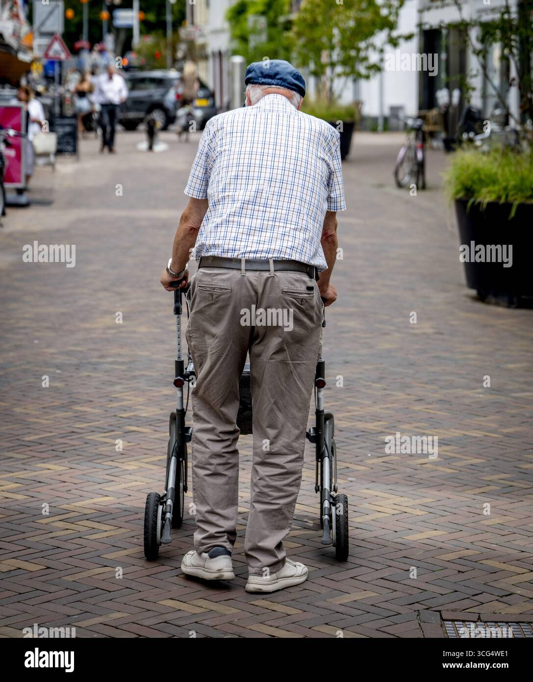 GOUDA - A man behind a walker on the street. ANP /HOLLANDSE HOOGTE ...