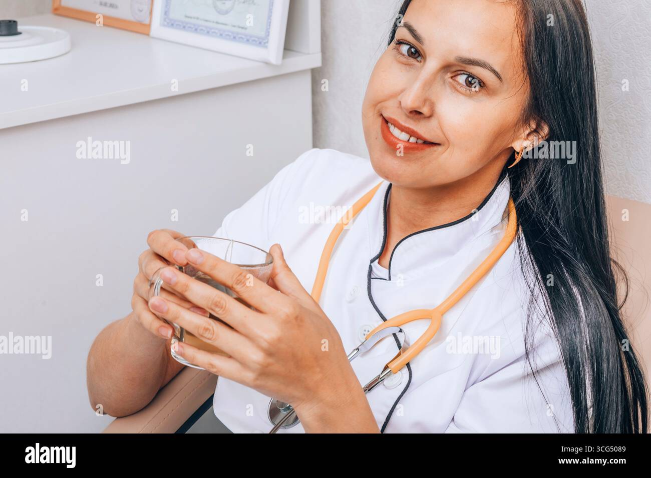 healthcare professional takes a brief pause to refresh with a cup of ...