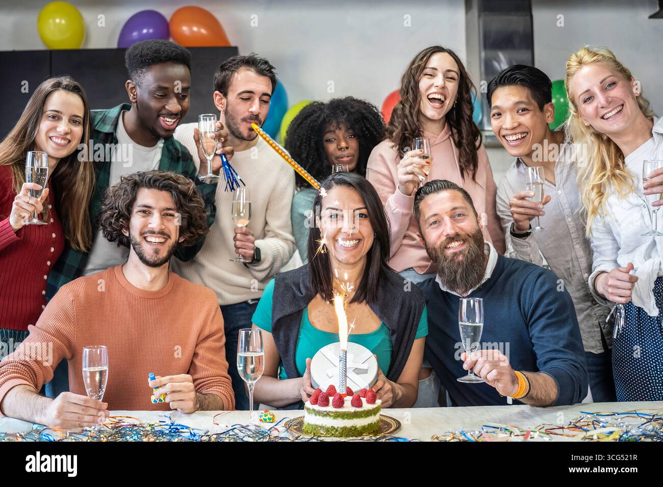 Group of young multiethnic friends celebrating a birthday with cake ...