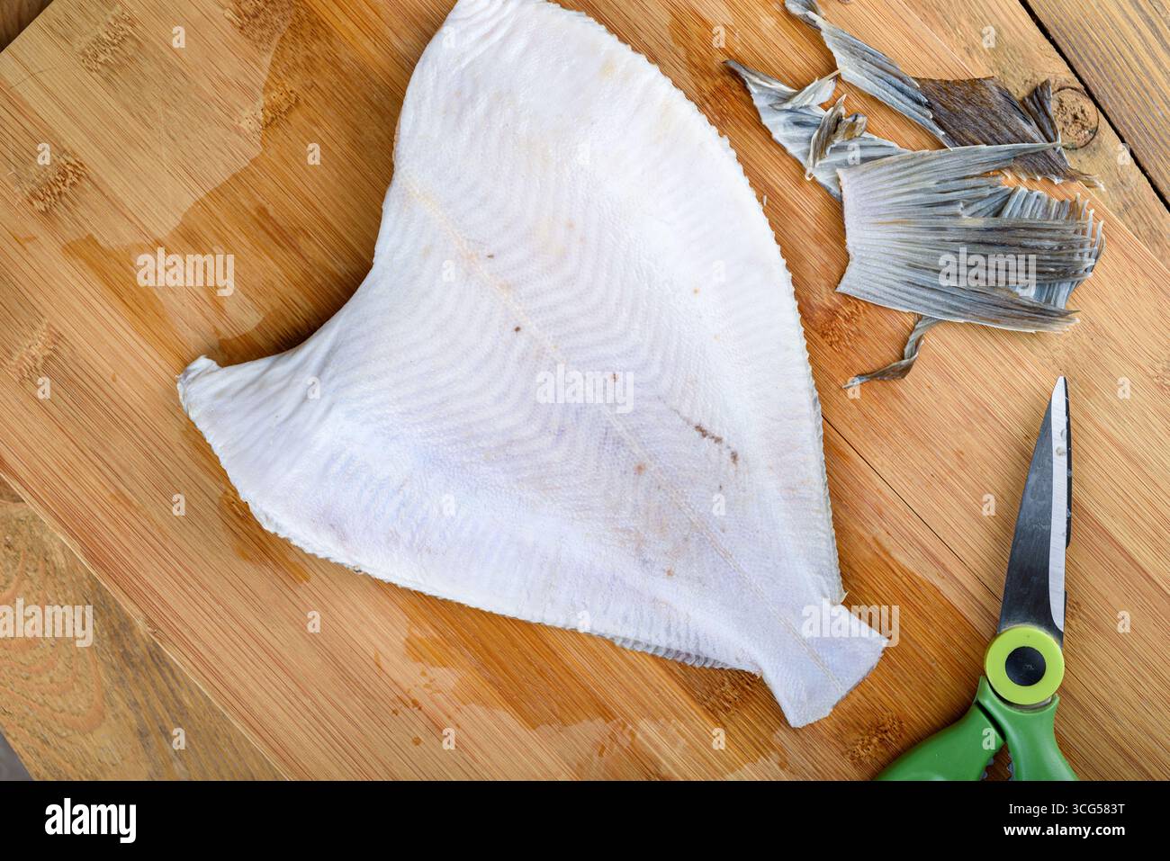 Flounder fish with fins and tail cut off before cooking. Home cooking ...